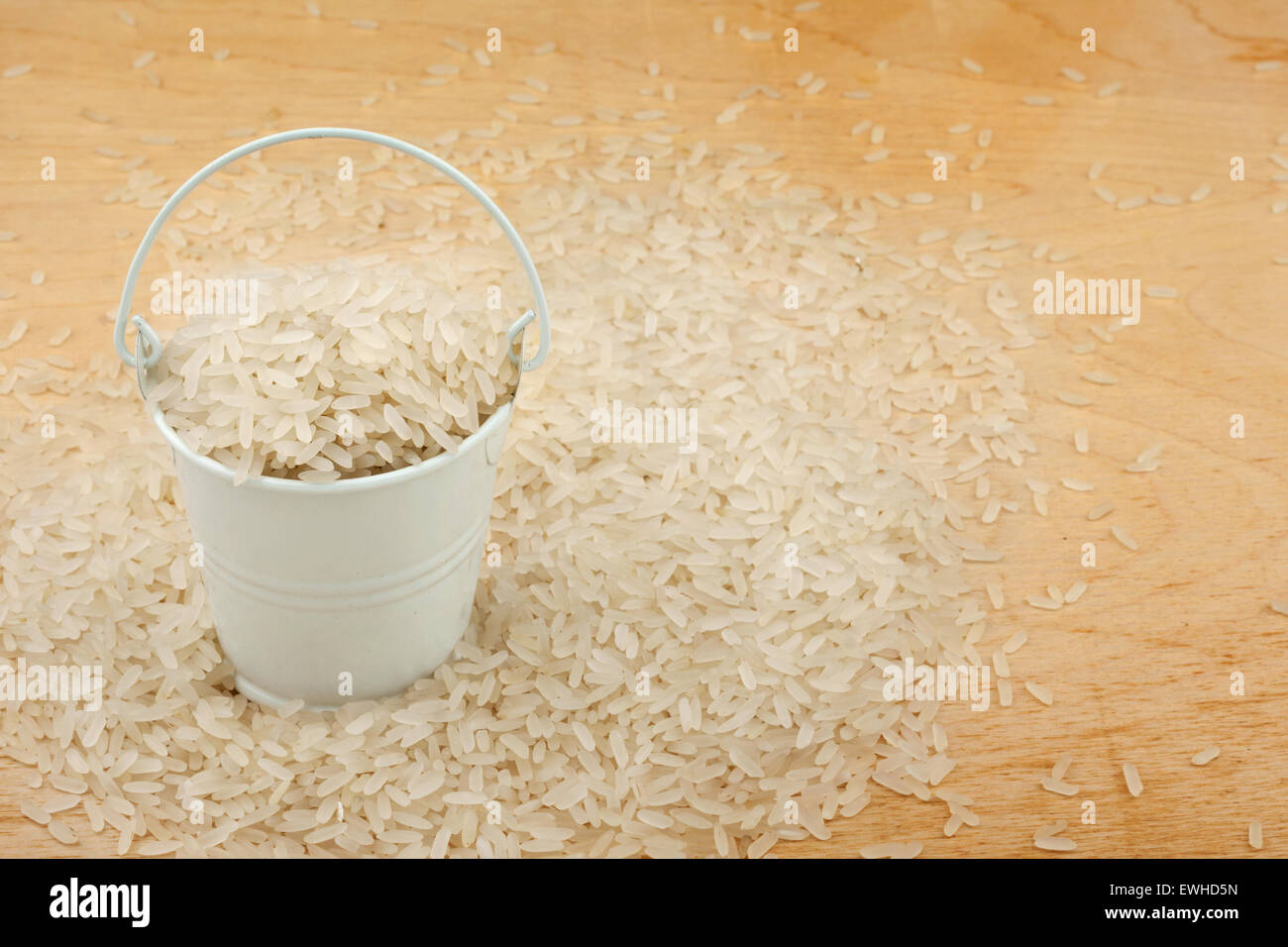 White bucket of rice on the wooden floor, as a background Stock Photo ...