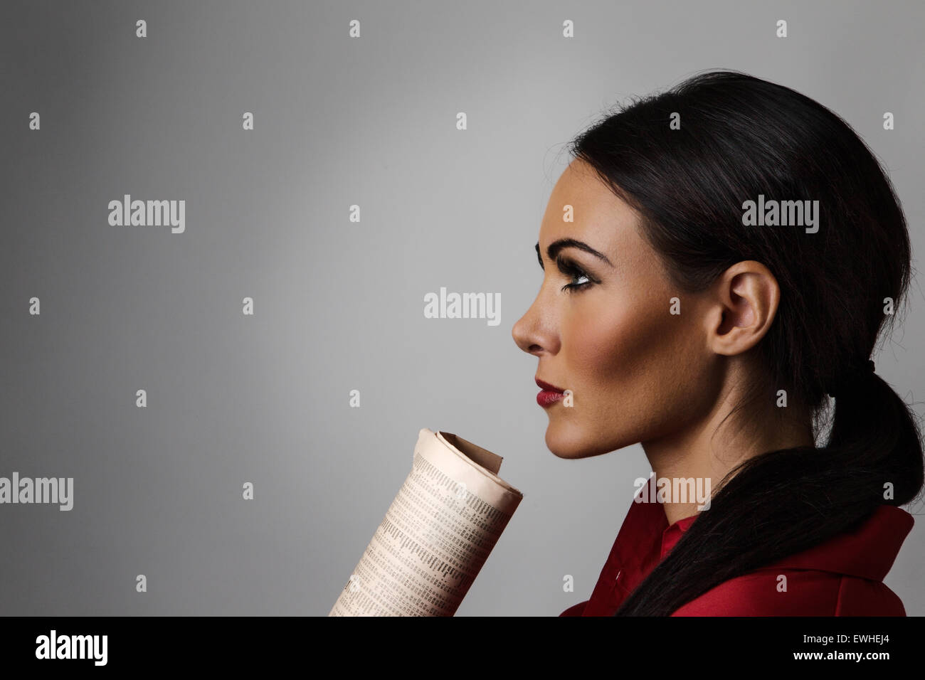 woman holding a financial paper showing stock and shares Stock Photo ...