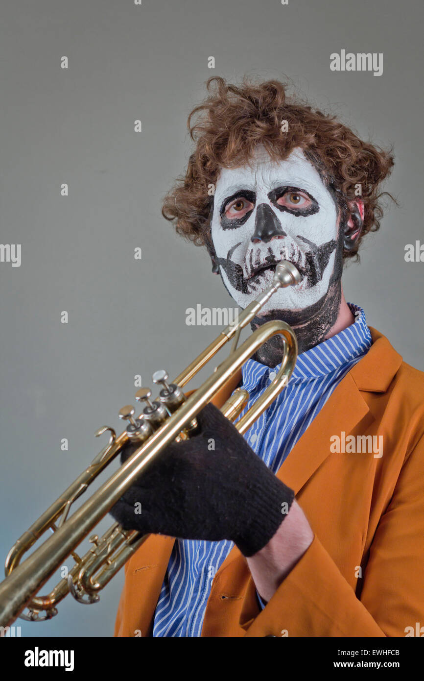 Crying trumpet player with face painted as human skull Stock Photo - Alamy