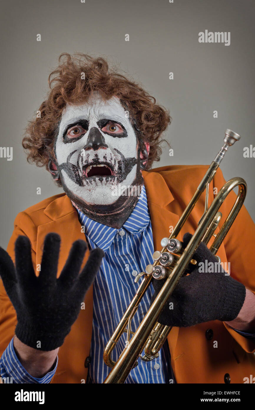 Pleading trumpet player with face painted as human skull Stock Photo ...