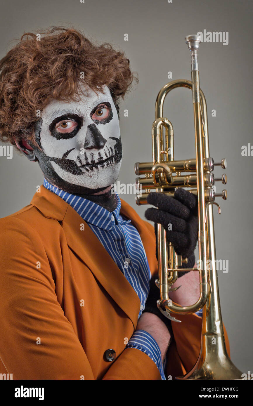 Confident trumpet player with face painted as human skull Stock Photo ...
