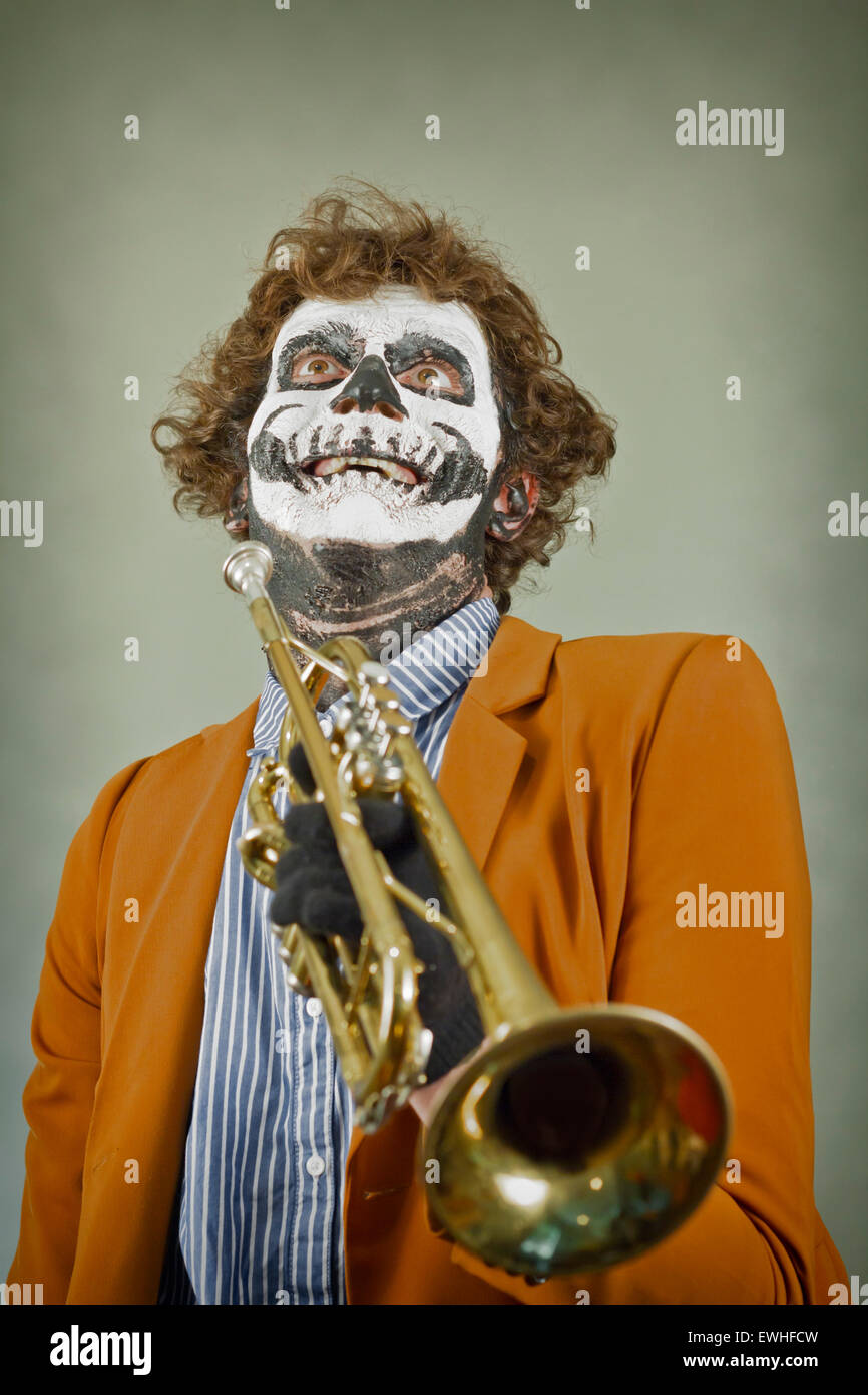 Professional trumpet player with face painted as human skull Stock ...