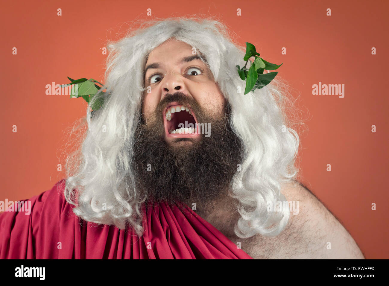 Angry screaming wrath of god against orange background Stock Photo - Alamy