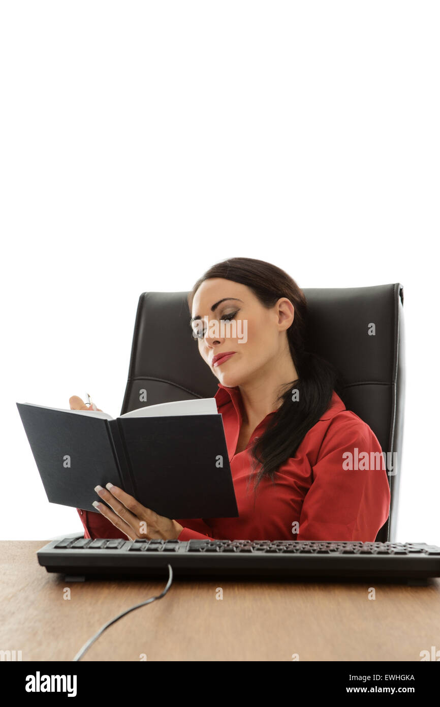 business woman siting at her office desk reading a book Stock Photo - Alamy