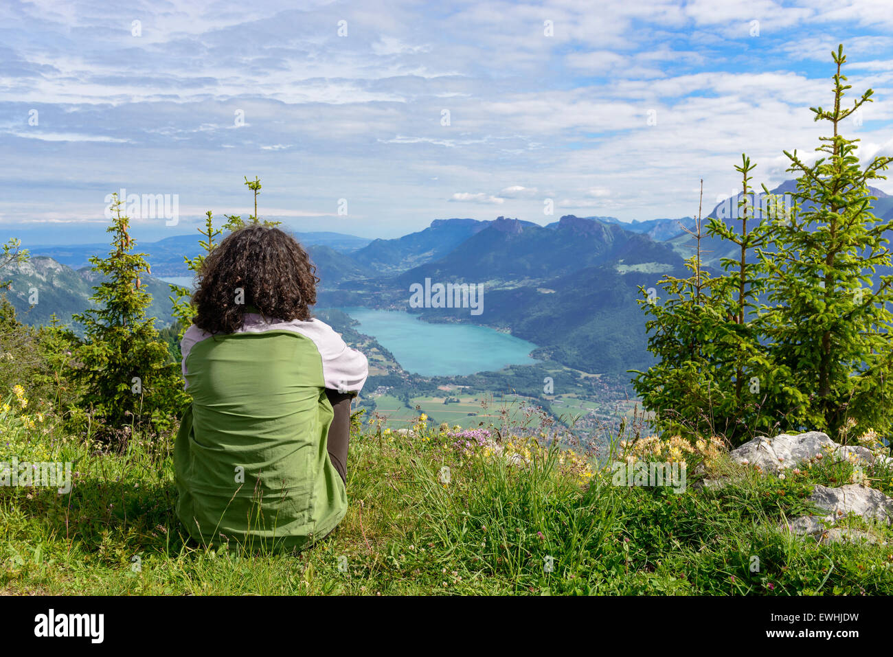 woman sitting on cliff and looking at landscape Stock Photo - Alamy