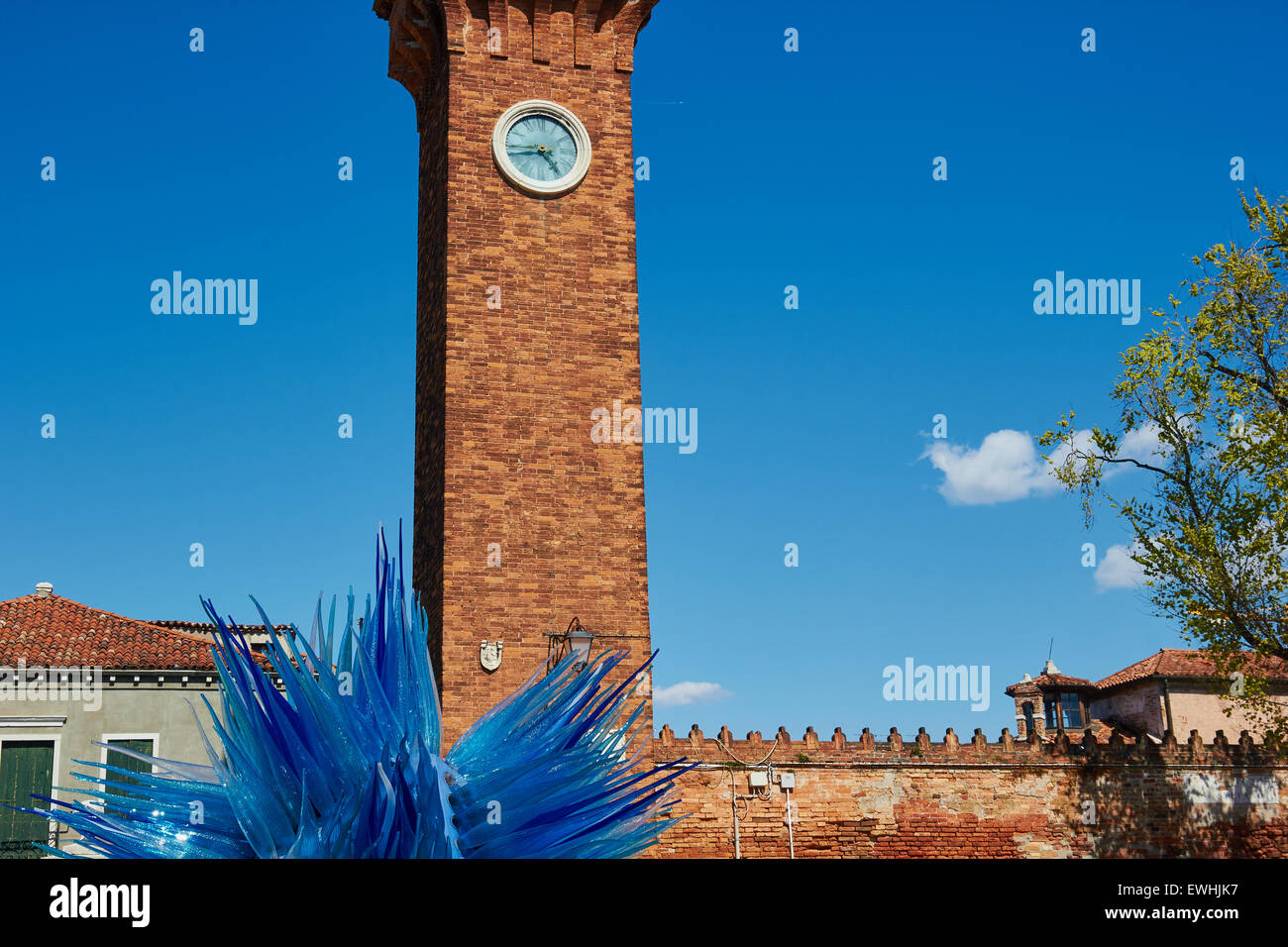 Clock tower and blue glass sculpture in Campo Santo Stefano Murano ...