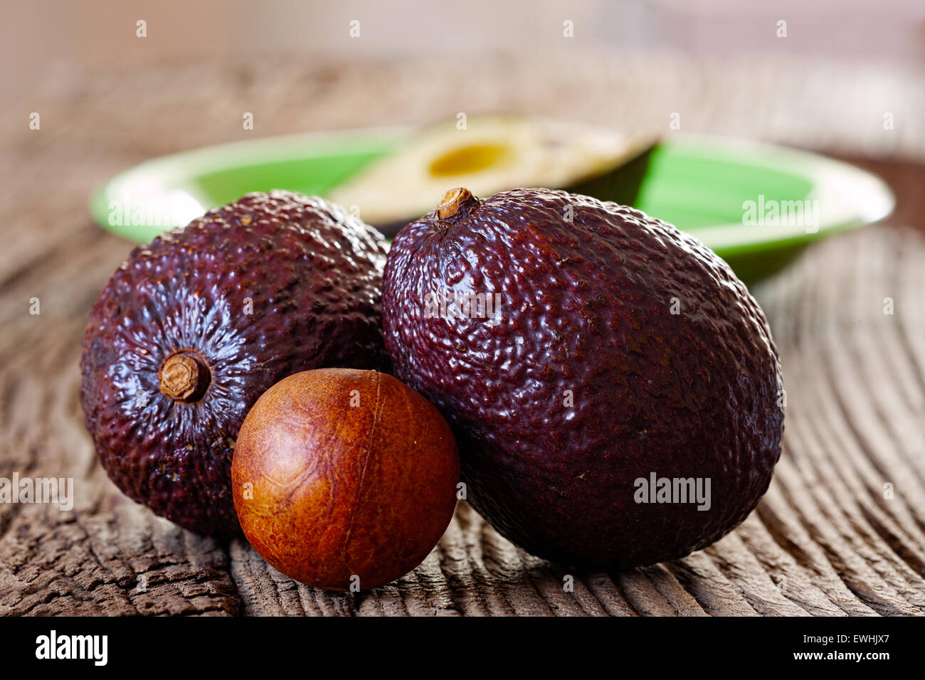 Two ripe avocados and avocado core on an old rustic wooden plank Stock ...