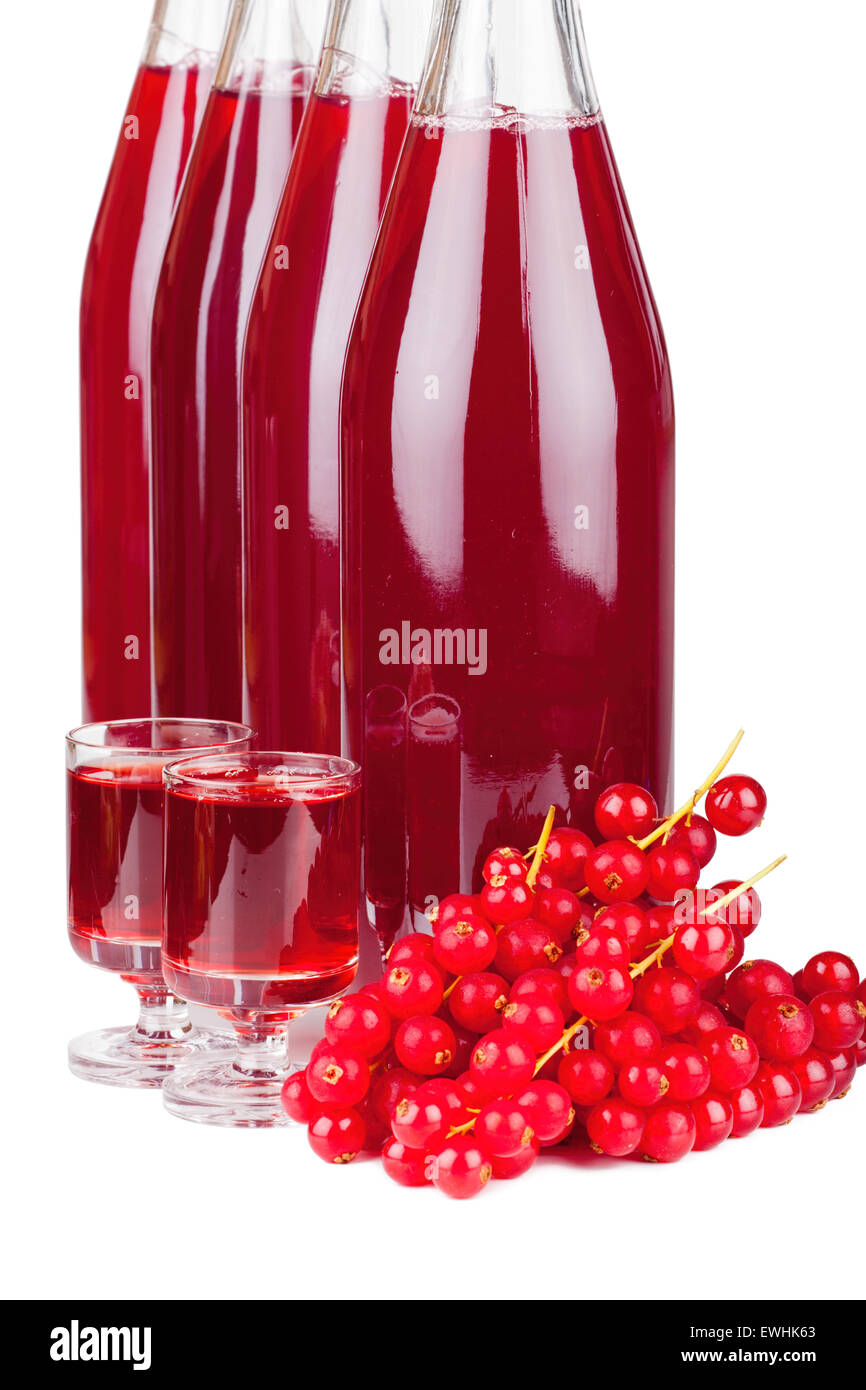Ripe red currants and syrup or liqueur in a glass and swing top bottles ...