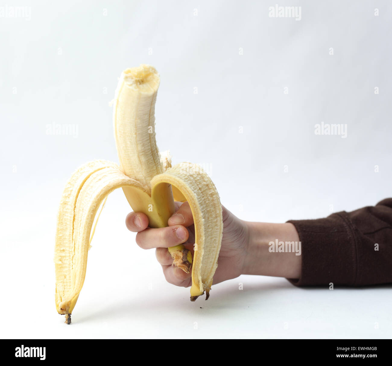banana in hand on a white background Stock Photo - Alamy