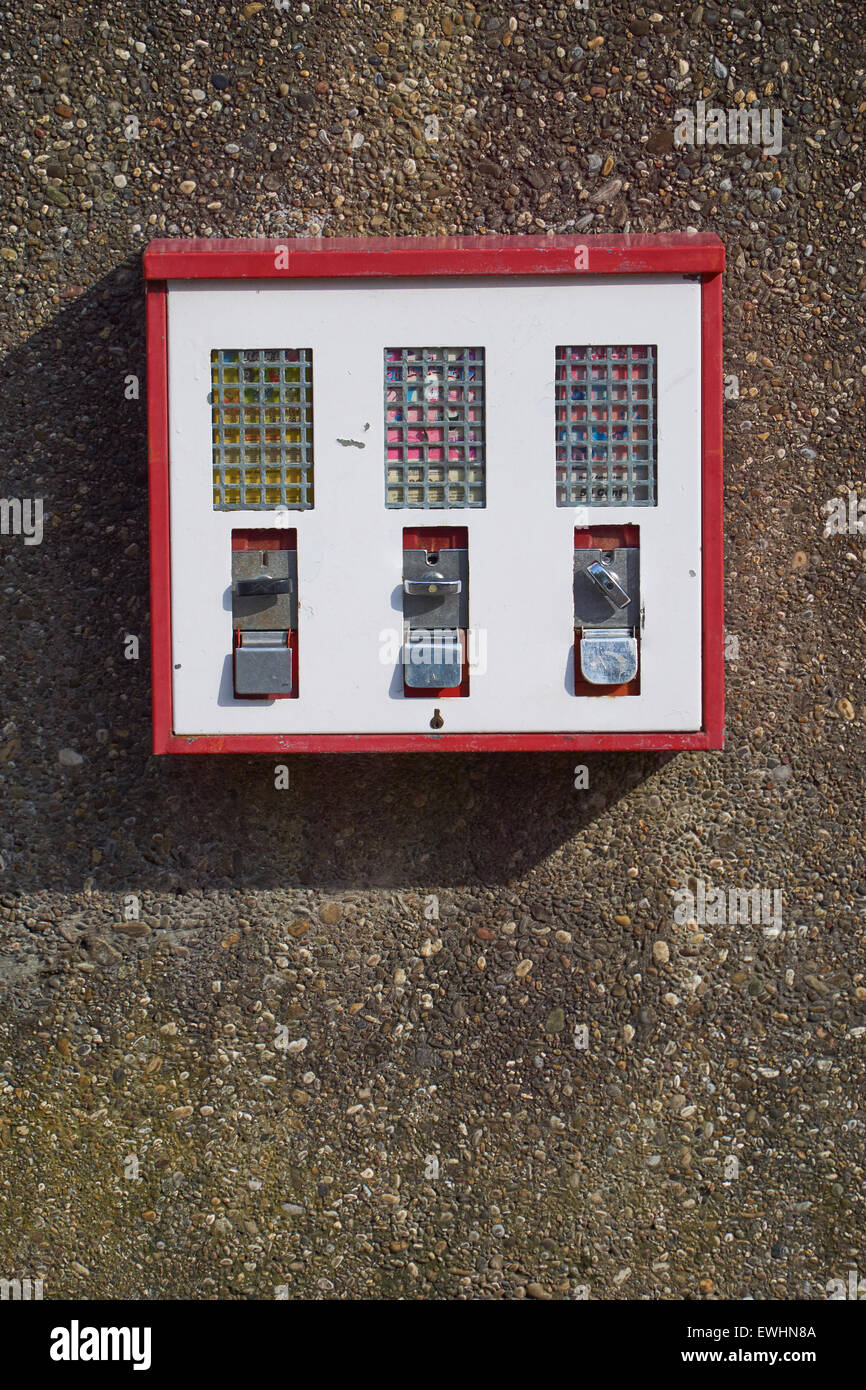 Three Chewing gum machines on an old house wall Stock Photo - Alamy