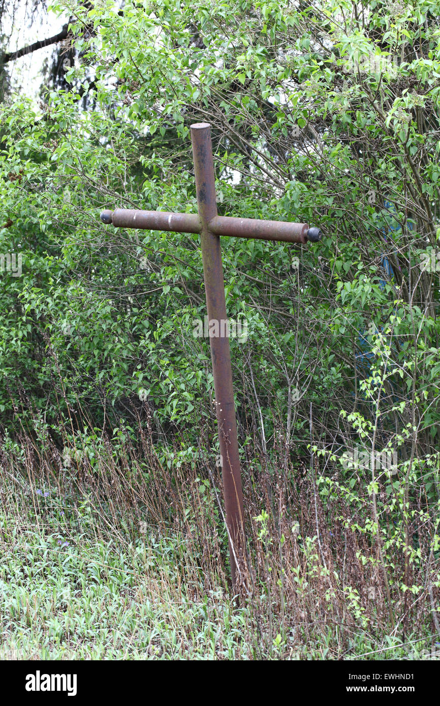 old metal cross in the bushes and trees Stock Photo - Alamy