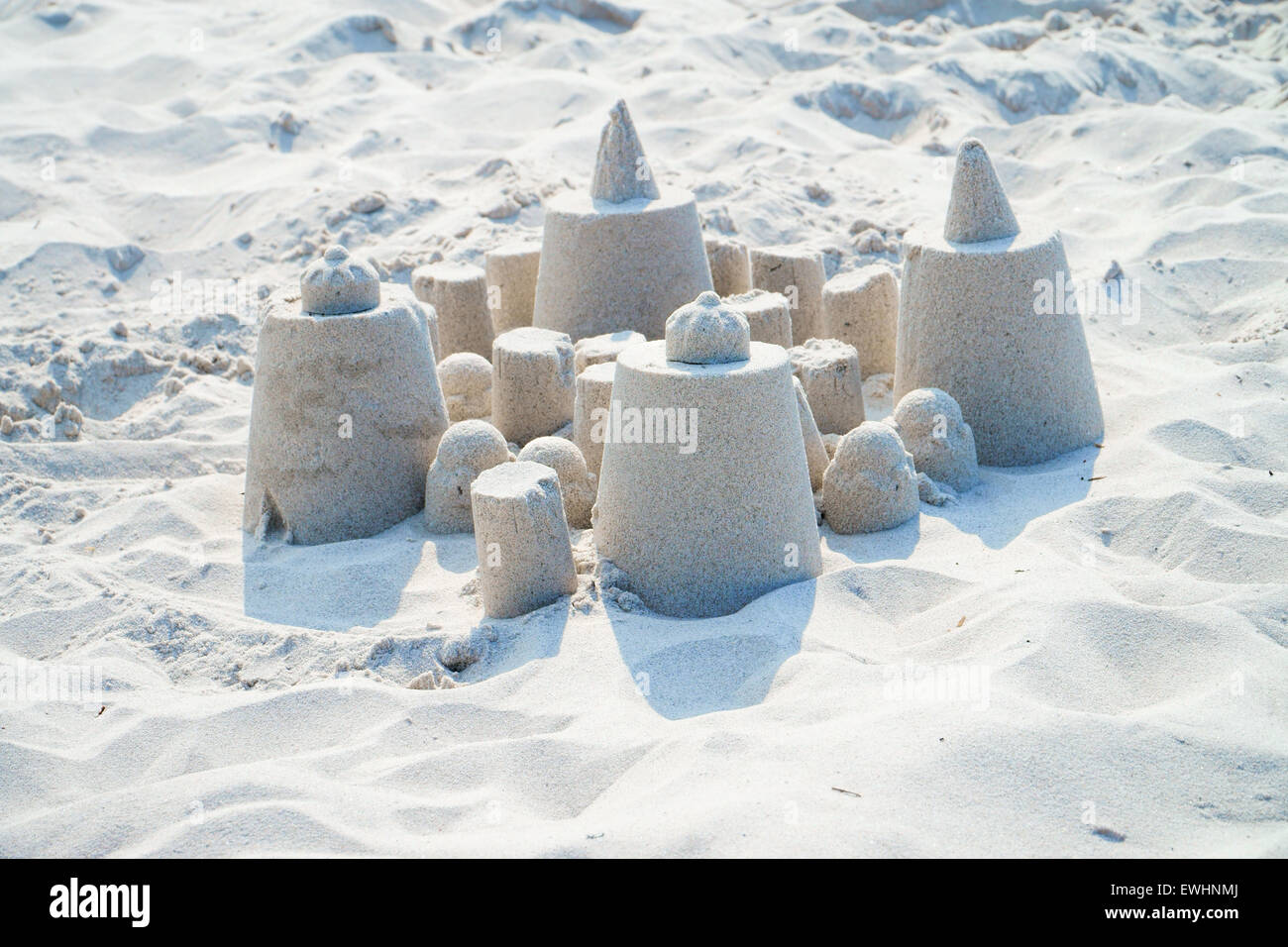 Small sand castle on the sunny beach Stock Photo - Alamy