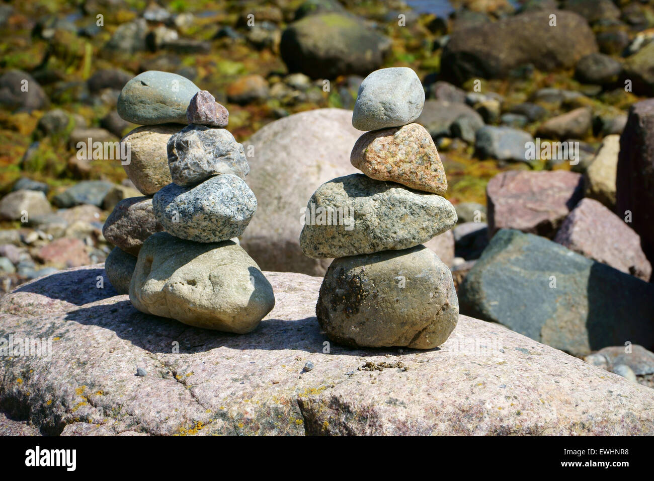 Three Stacks of pebble stones on a rock on the coast Stock Photo - Alamy