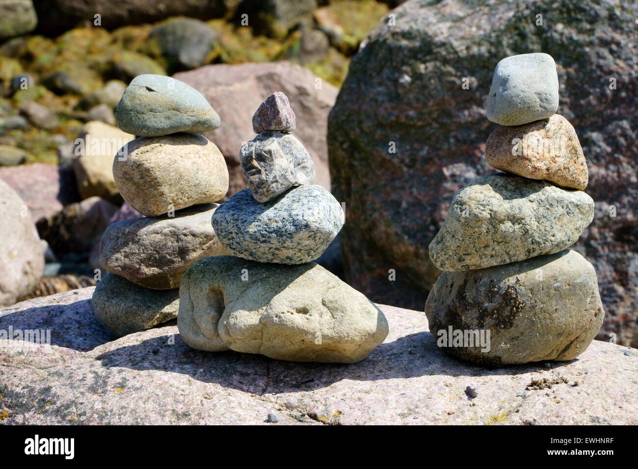 Three balanced Stacks of pebble stones on a rock Stock Photo - Alamy