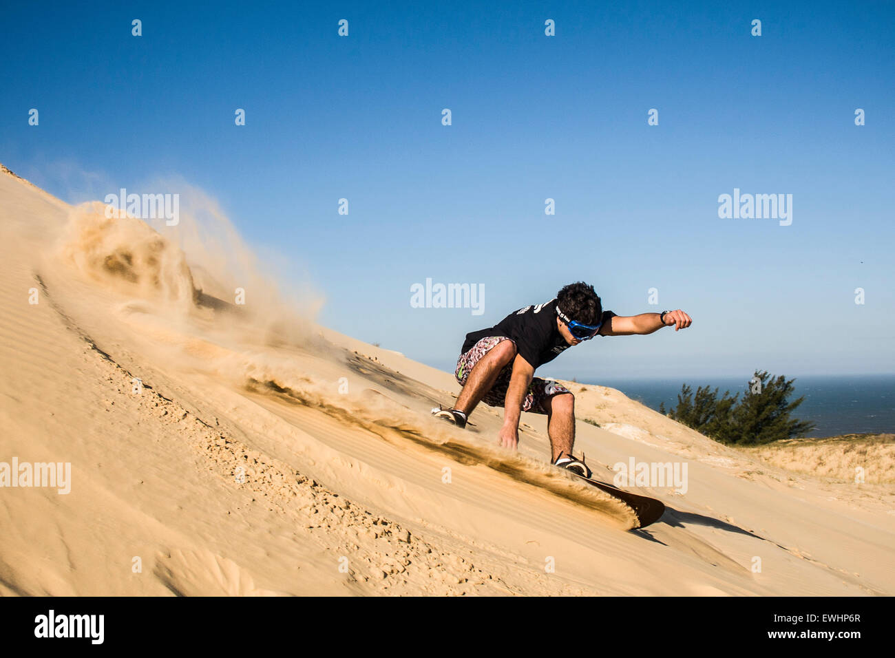 Sandboarding on the dunes of Cape of Santa Marta. Laguna, Santa ...