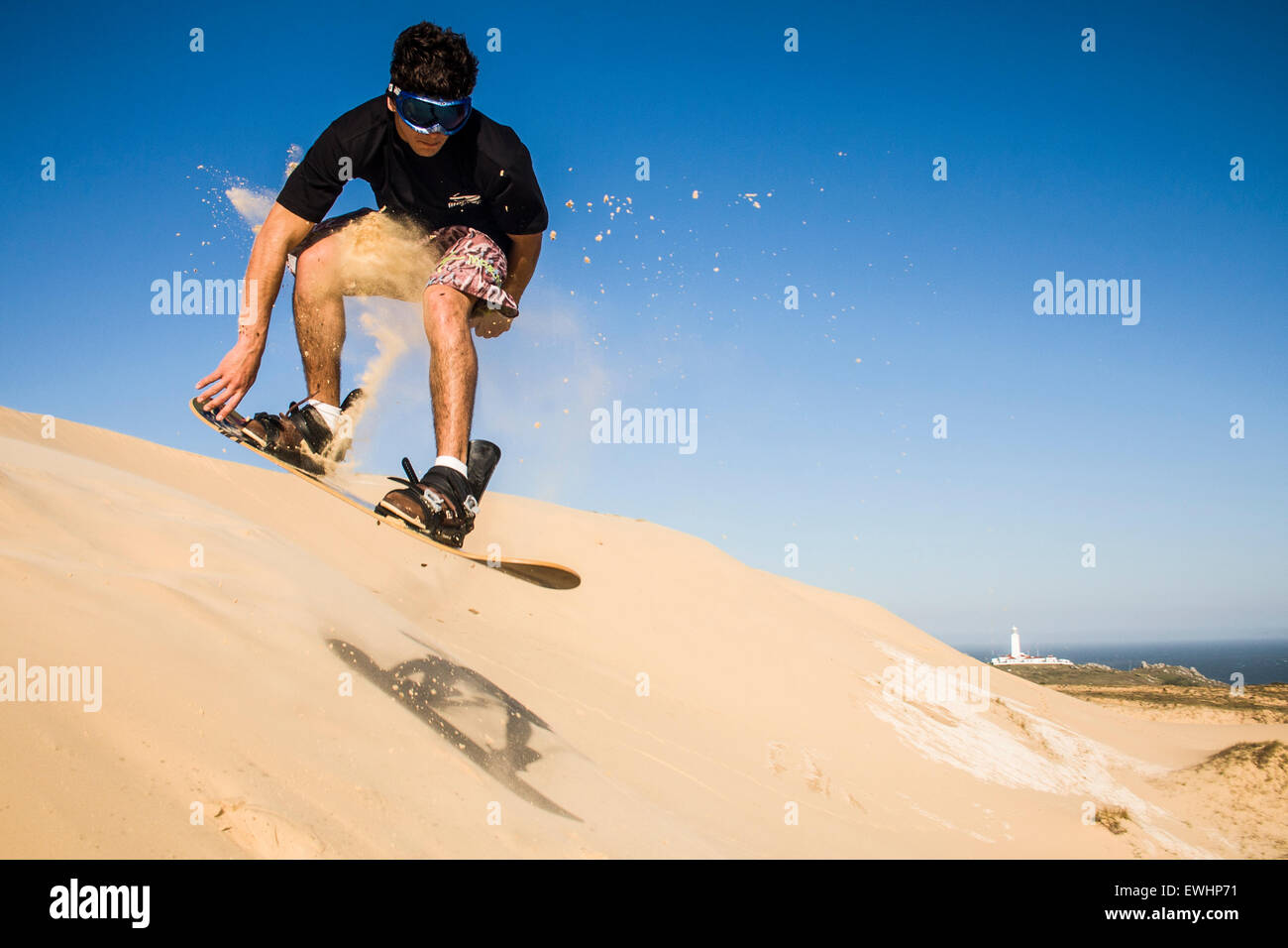 Sandboarding on the dunes of Cape of Santa Marta. Laguna, Santa ...