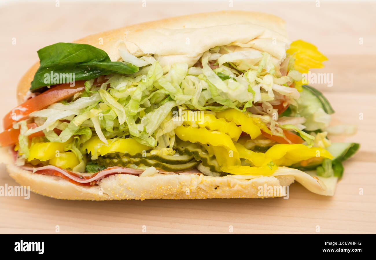 A loaded italian sub sandwich with spinach, lettuce and peppers Stock ...