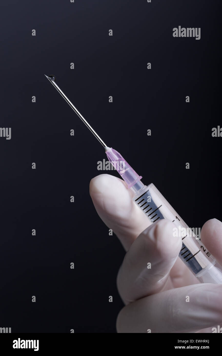 Hand with syringe Stock Photo - Alamy