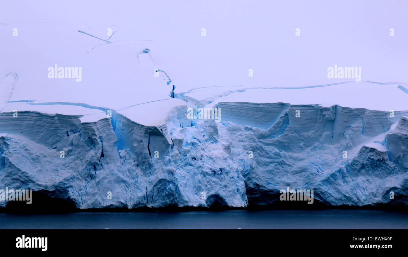 Cracks in the ice reveal a glowing blue core Stock Photo - Alamy