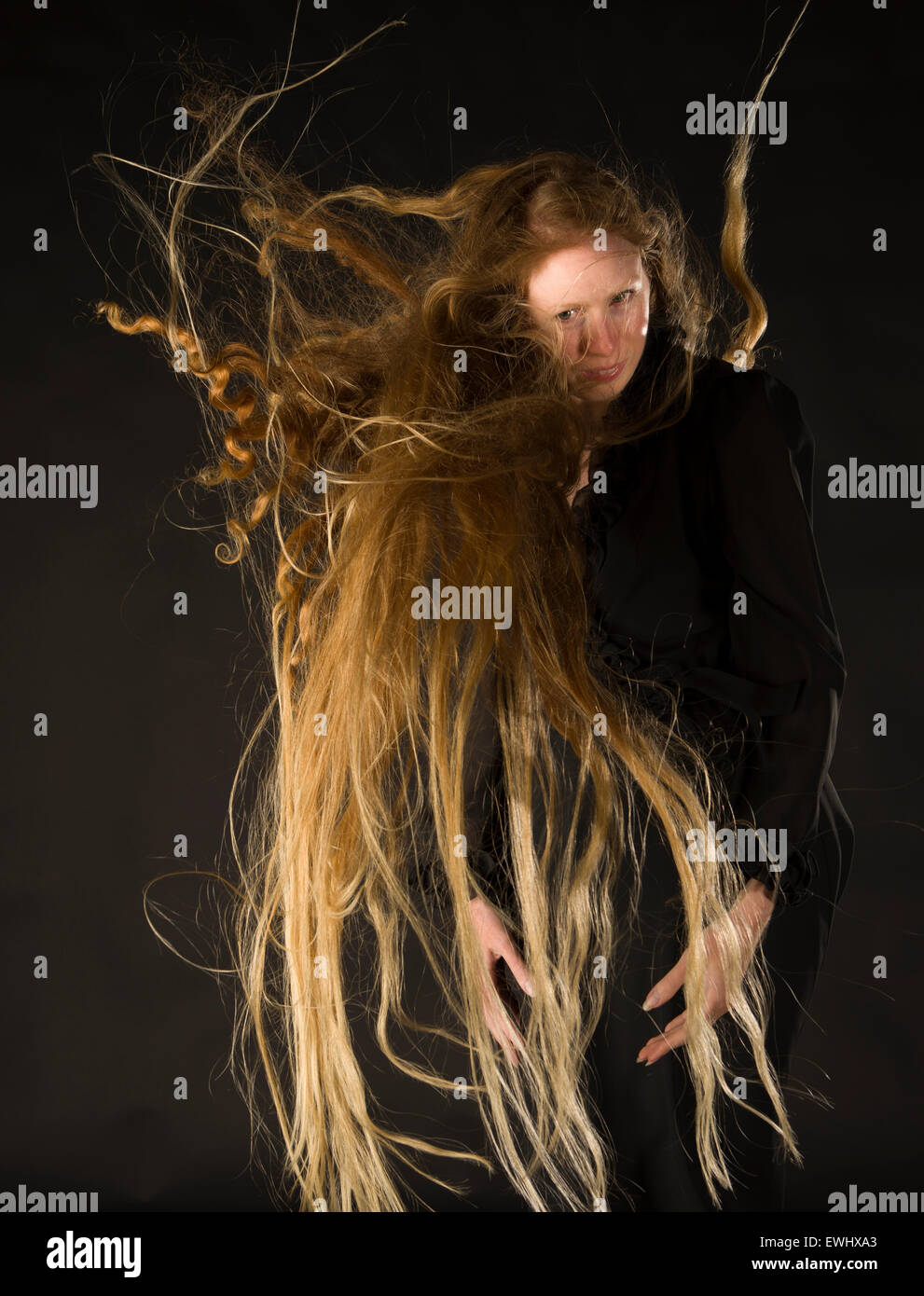 Blond Woman with Wind Blowing Through Long Hair Stock Photo - Alamy