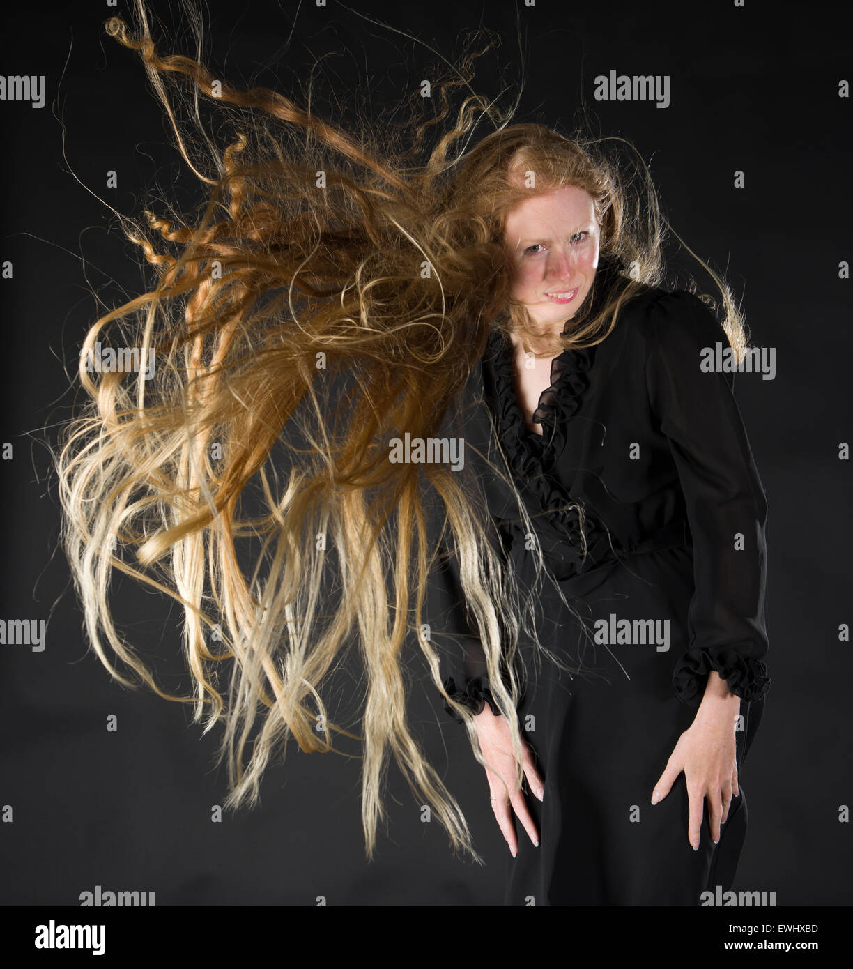Blond Woman with Wind Blowing Through Long Hair Stock Photo - Alamy