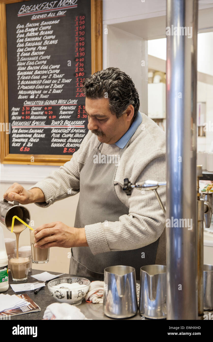 A cafe owner prepares a milkshake in a traditional london cafe Stock ...
