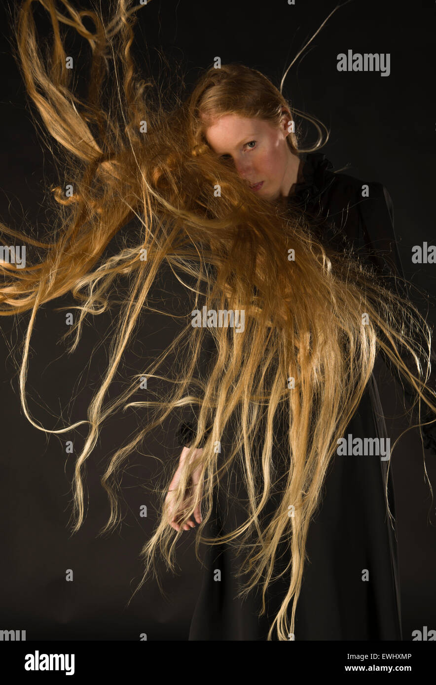 Blond Woman with Wind Blowing Through Long Hair Stock Photo - Alamy