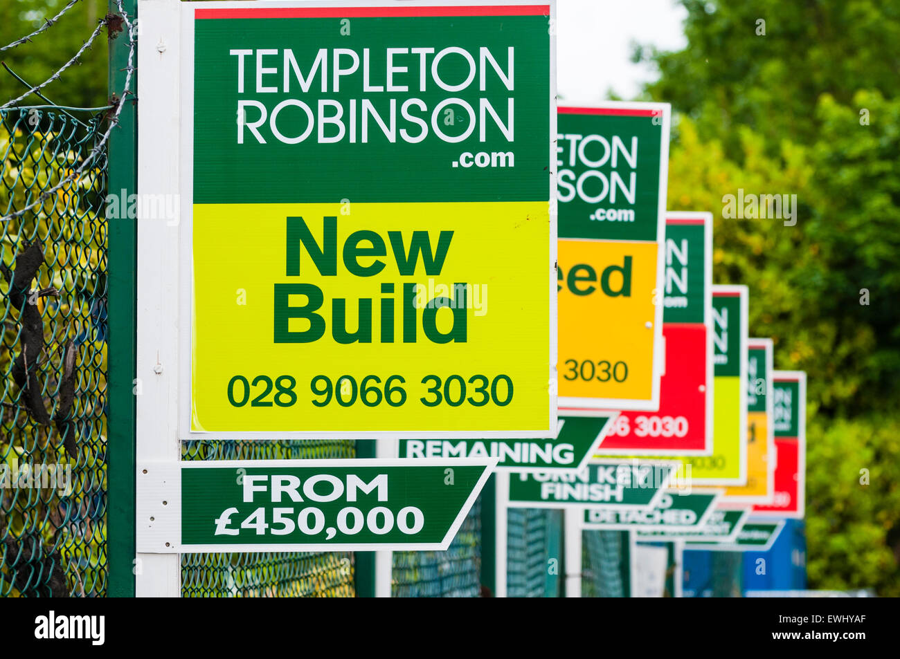Estate agent signs advertising "New Build", "Sale Agreed" and "Sold ...