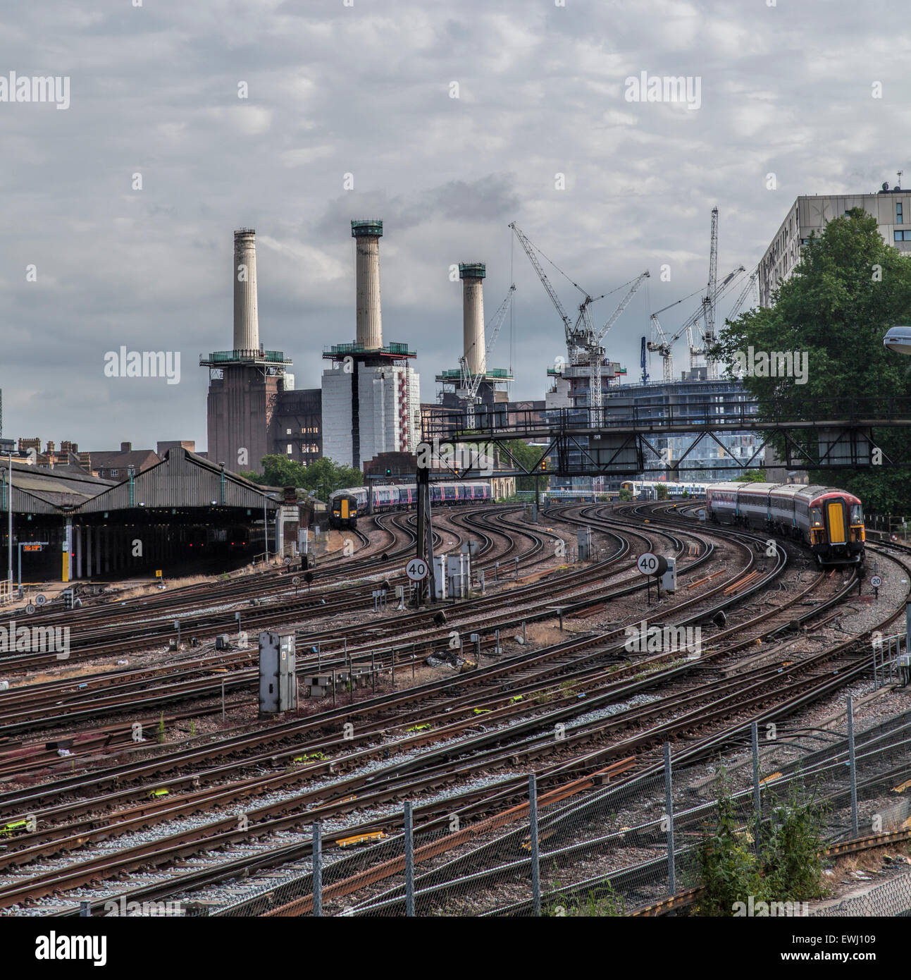 Two trains on a curved railway track approach Victoria Station with the ...