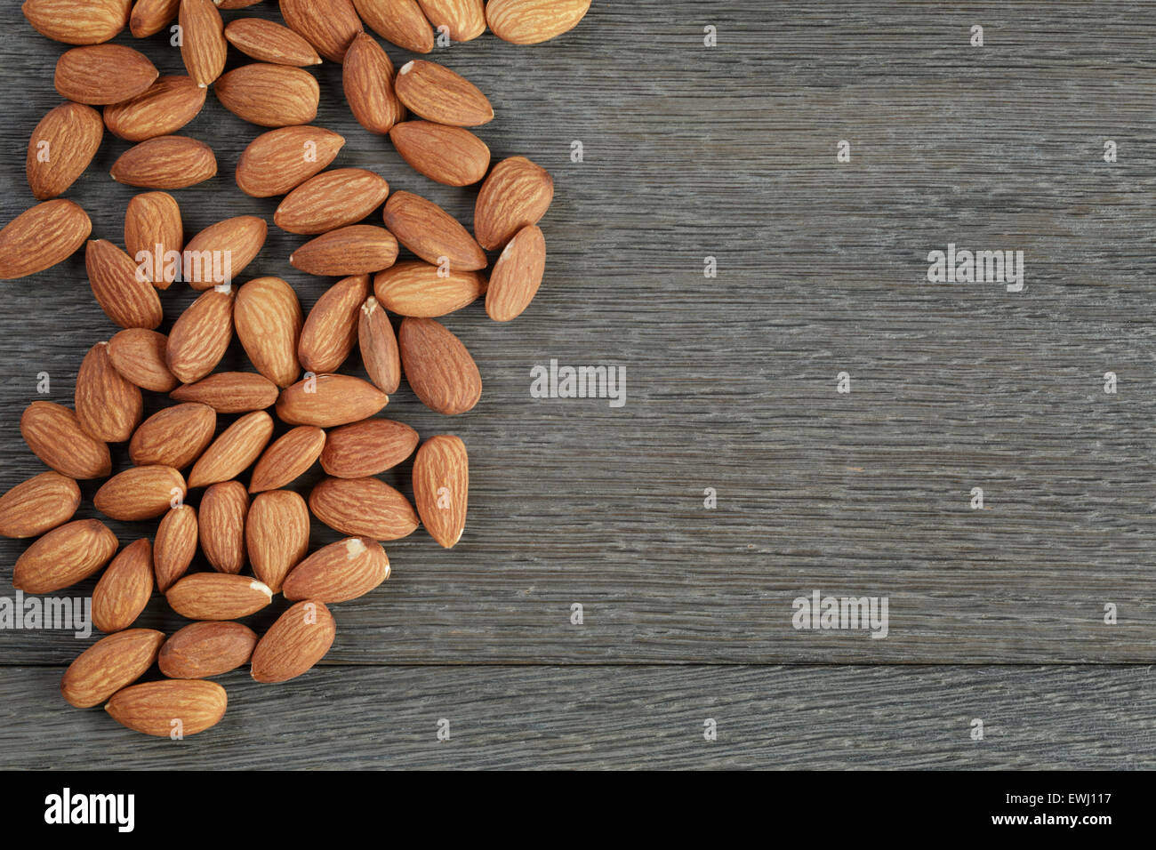 almonds on gray wooden table with copy space Stock Photo - Alamy