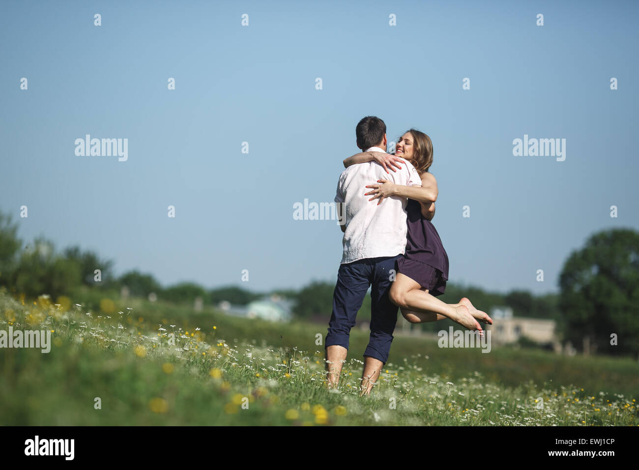 Couple running in field and have fun Stock Photo - Alamy