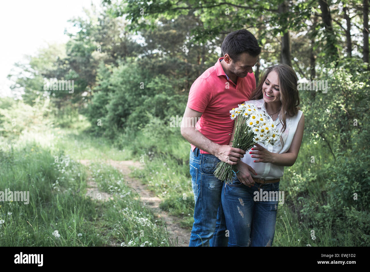 Cute couple in a forest Stock Photo - Alamy