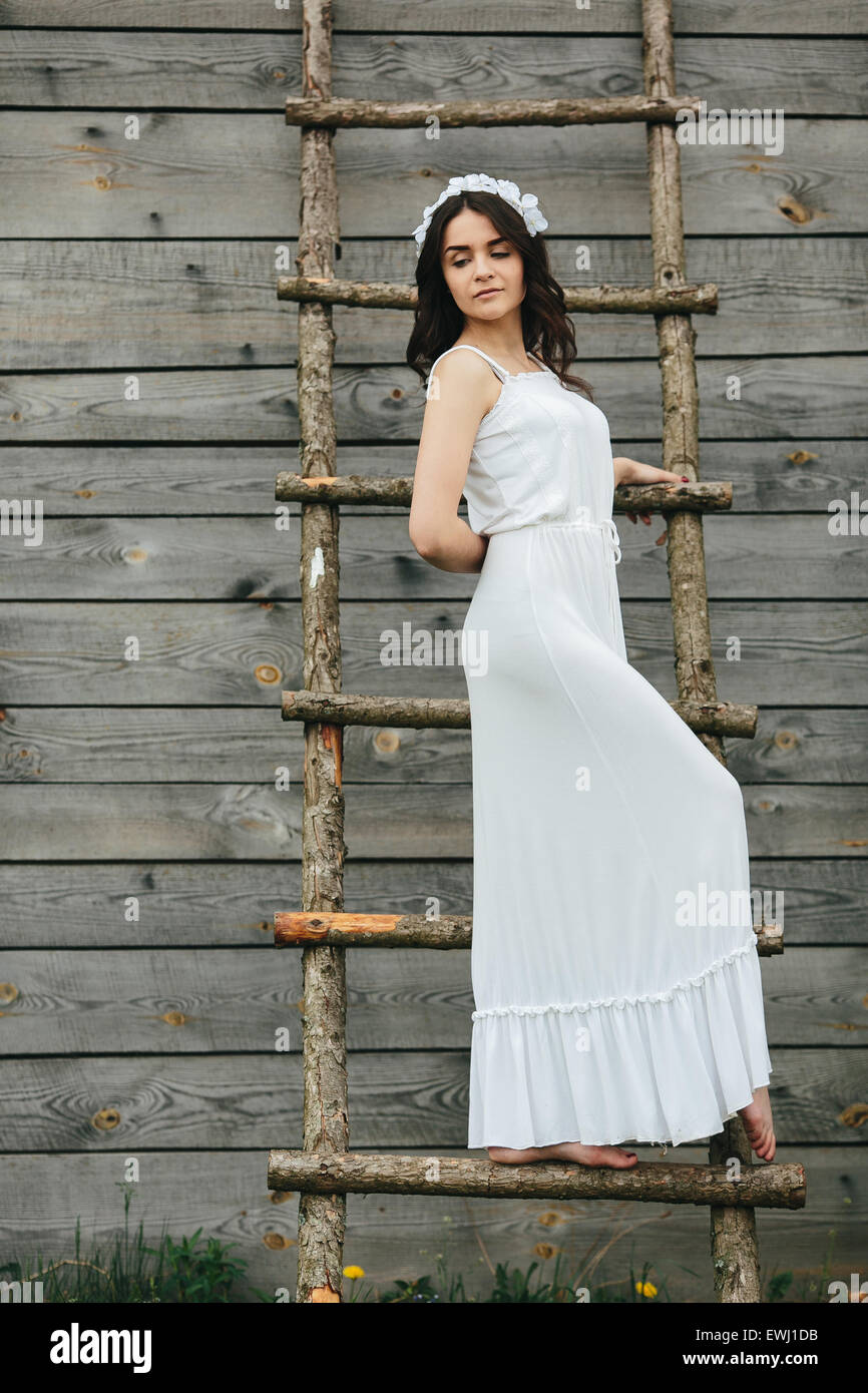 Girl climbing ladder into tree house Stock Photo - Alamy