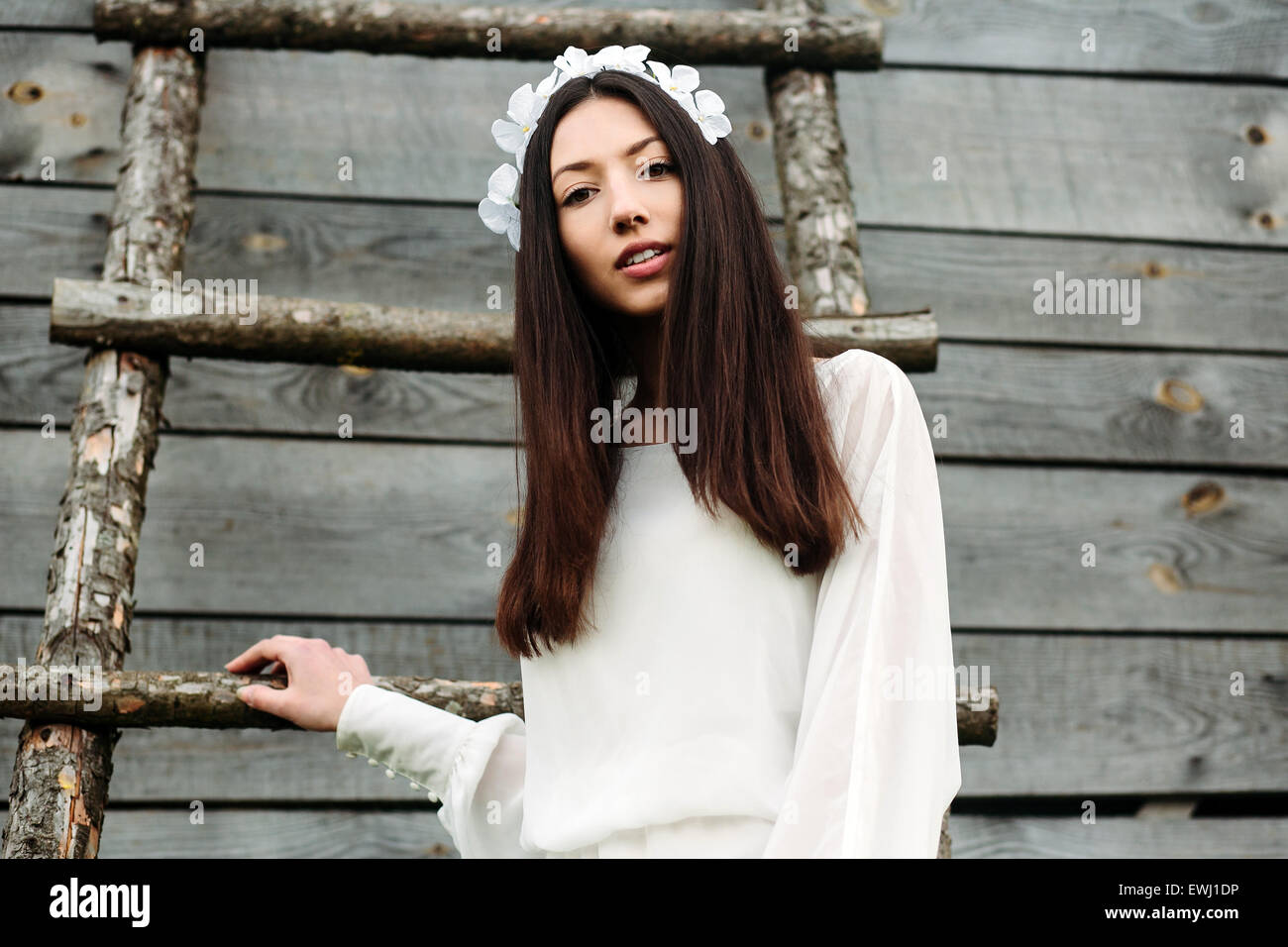 Girl climbing ladder into tree house Stock Photo - Alamy