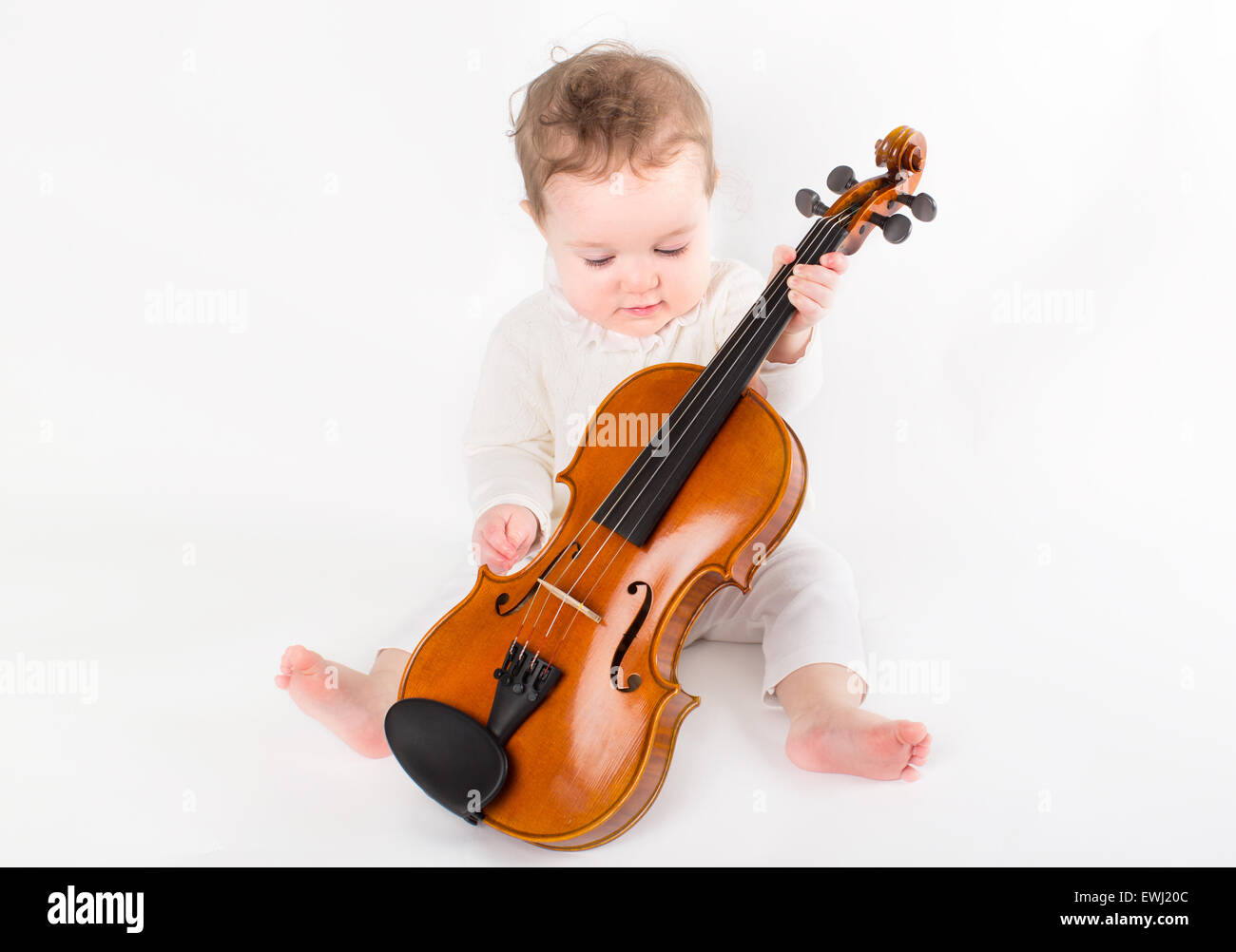 Beautiful baby girl playing with a violin Stock Photo - Alamy
