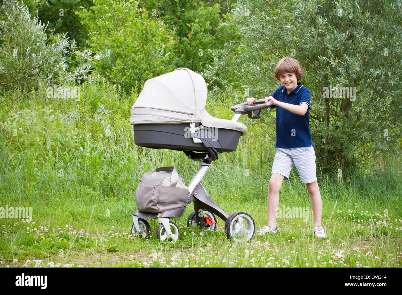 Person pushing baby in a pushchair hi-res stock photography and images ...