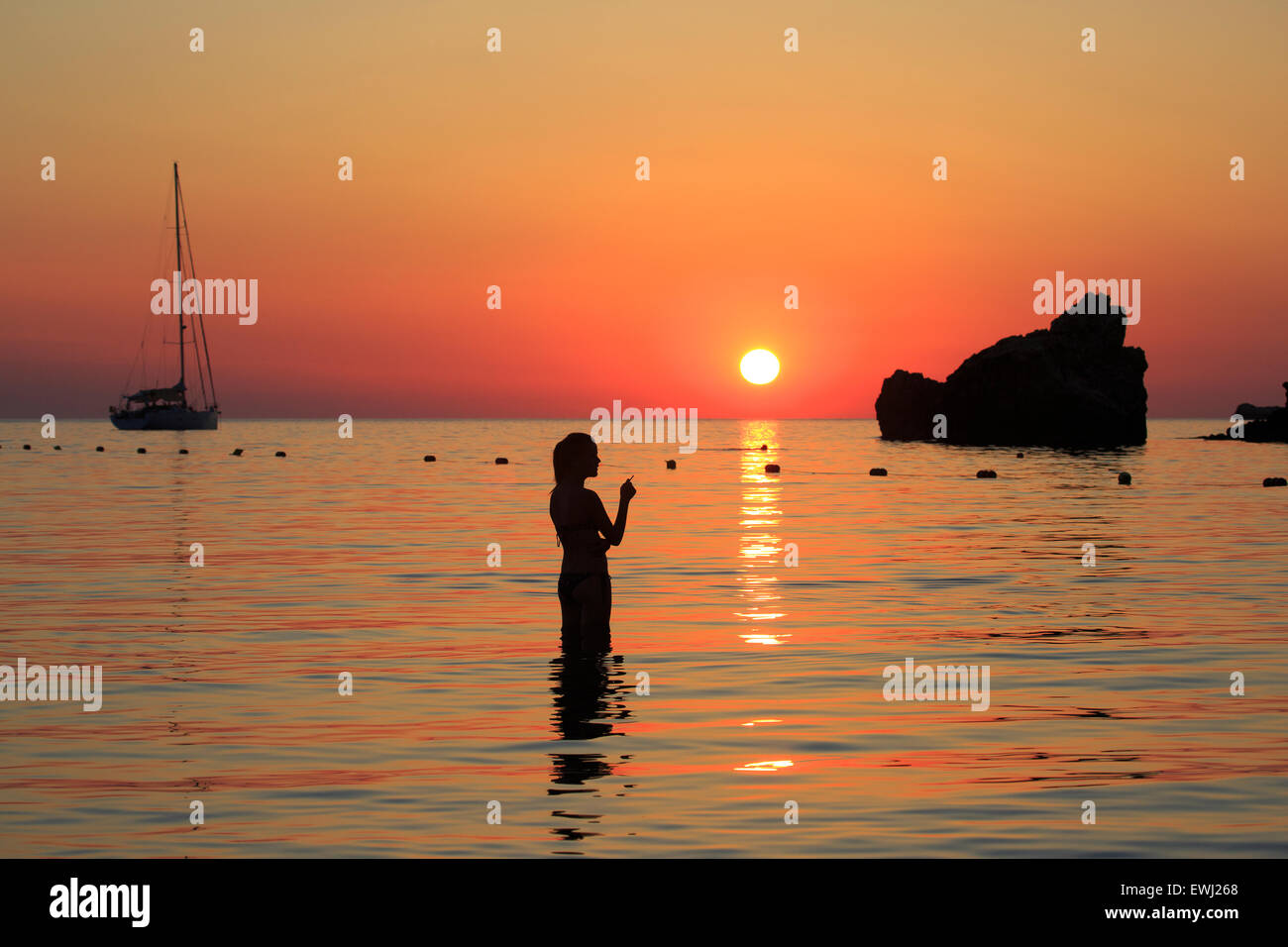 Silhouette of a girl watching beautiful sunset hi-res stock photography ...