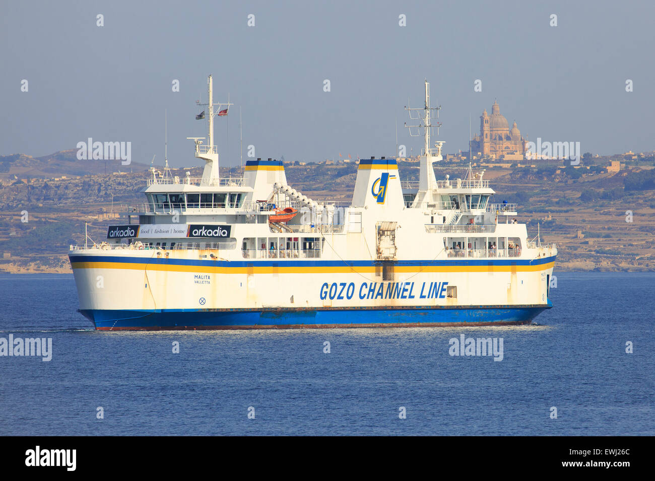 The Gozo Channel Line ferry between Malta and Gozo with Nadur Basilica ...