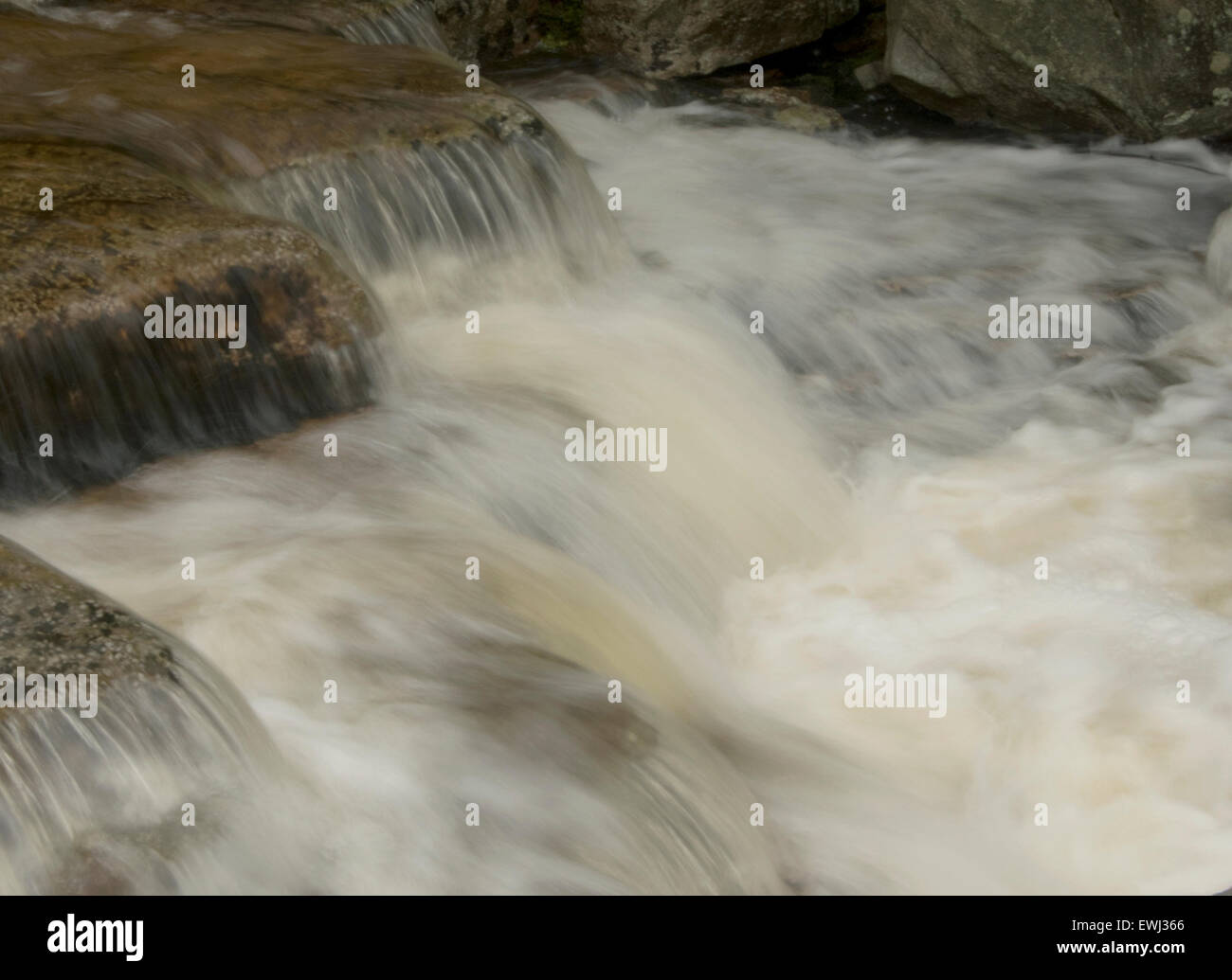 rushing stream through granite boulders after summer storm Stock Photo ...