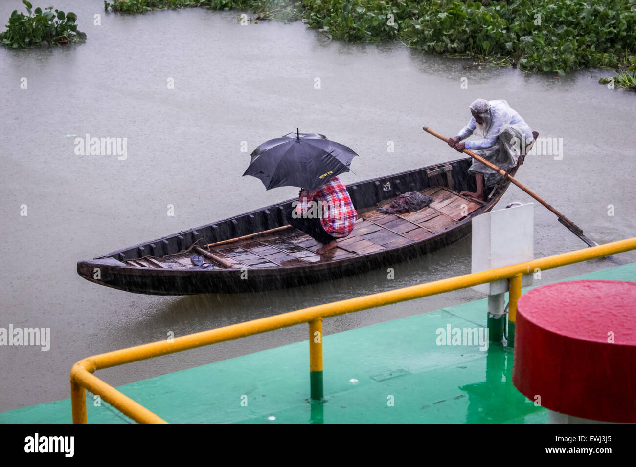 Dhaka, Bangladesh. 26th June, 2015. A boatman and a passenger on the ...