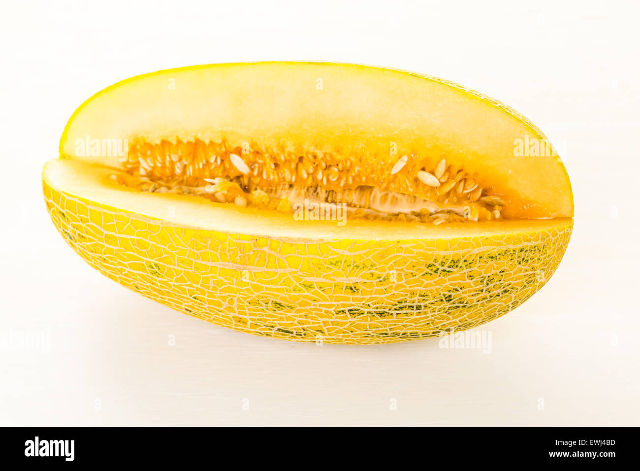 Organic Persian melon sliced on white wood board Stock Photo - Alamy
