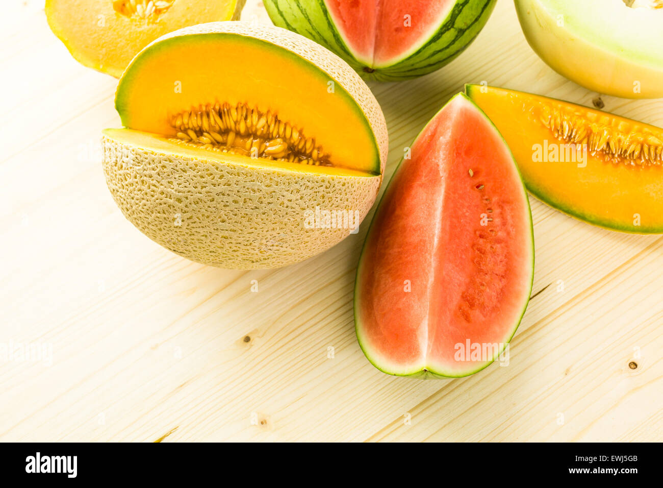 Variety of organic melons sliced on wood table Stock Photo - Alamy