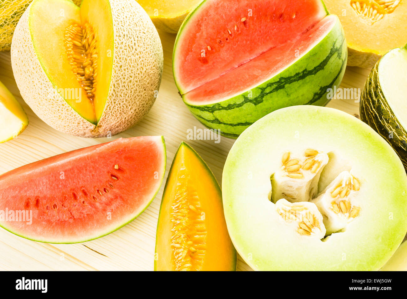 Variety of organic melons sliced on wood table Stock Photo - Alamy
