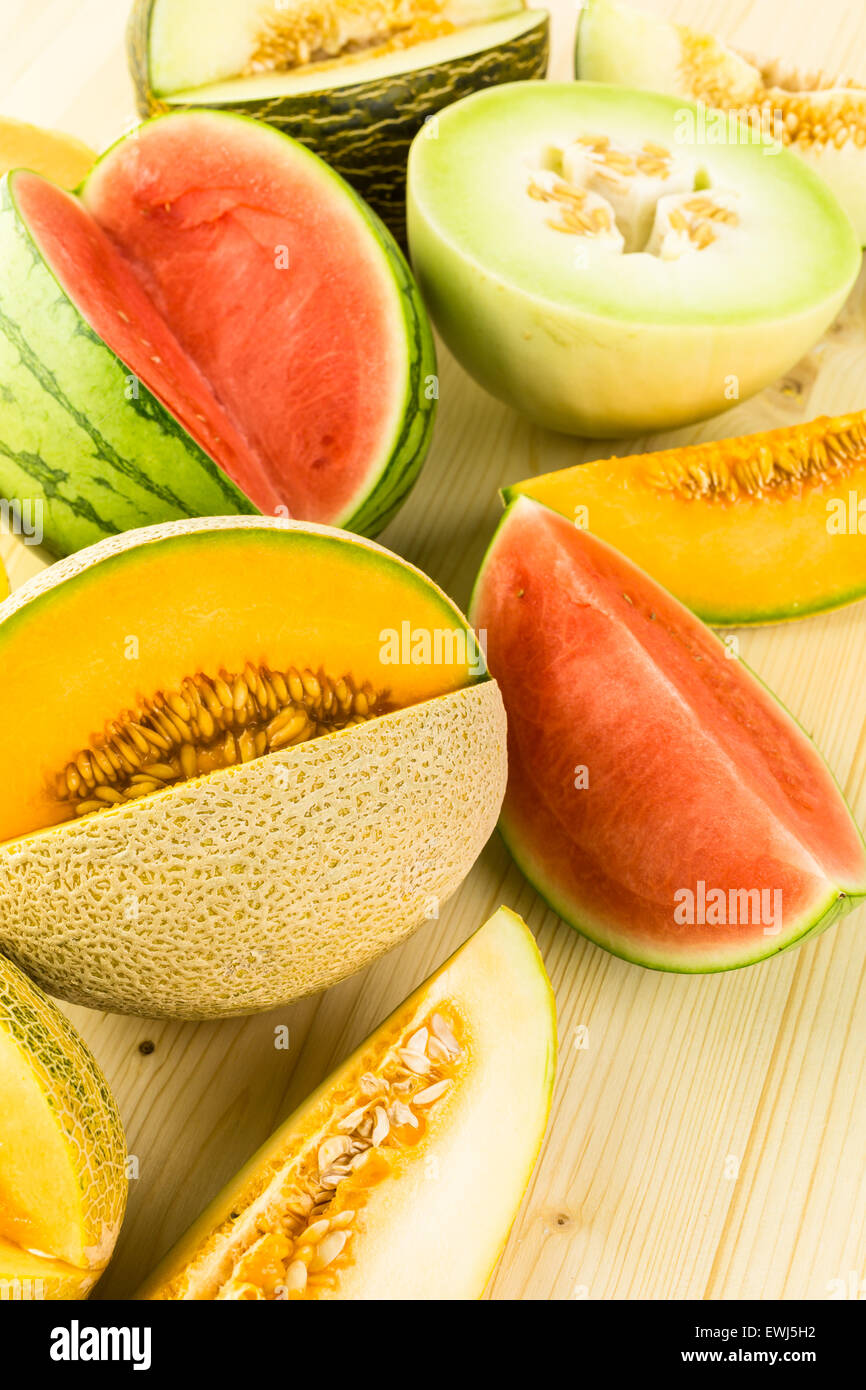 Variety of organic melons sliced on wood table Stock Photo - Alamy