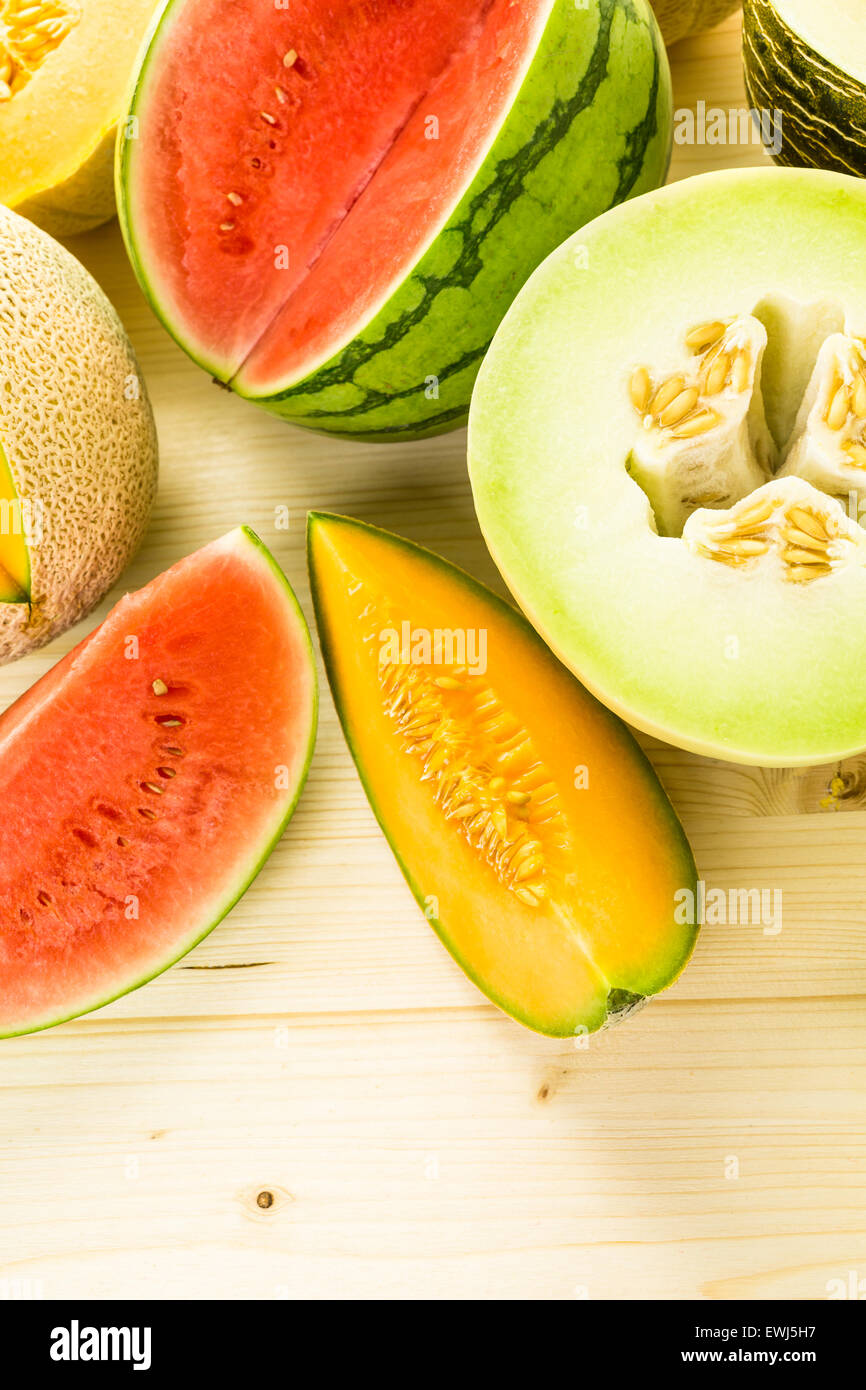 Variety of organic melons sliced on wood table Stock Photo - Alamy