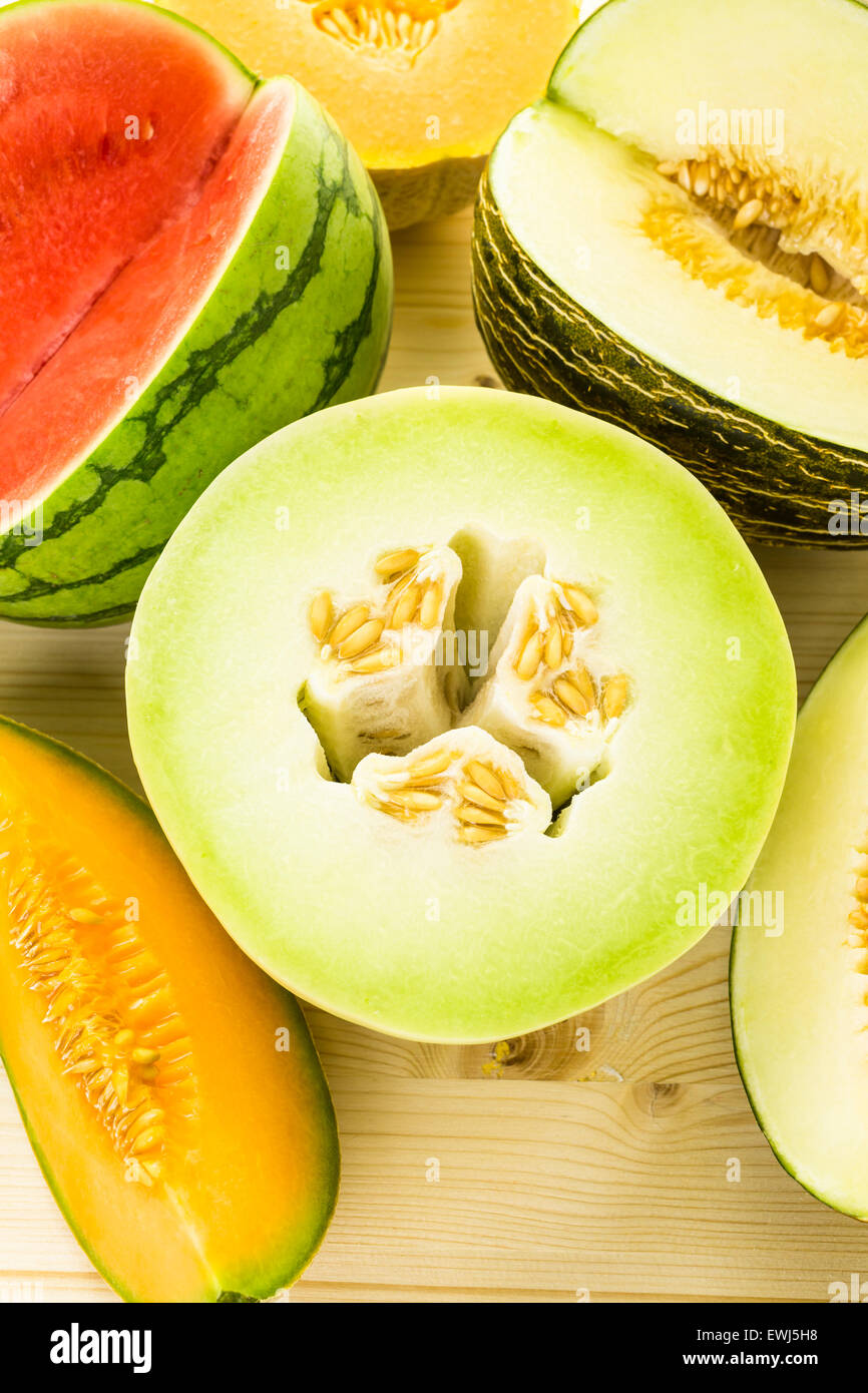 Variety of organic melons sliced on wood table Stock Photo - Alamy