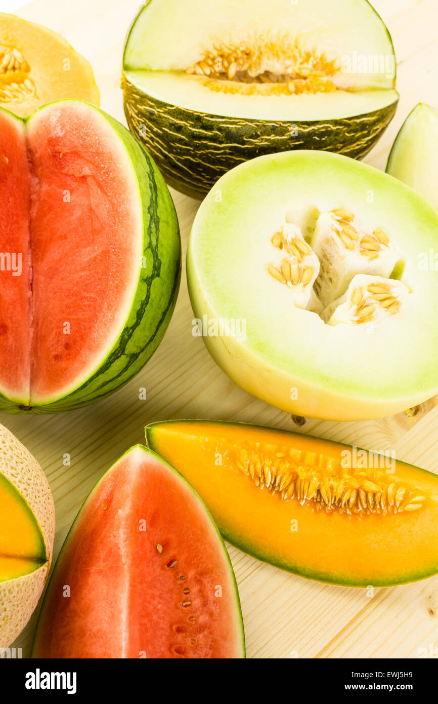 Variety of organic melons sliced on wood table Stock Photo - Alamy