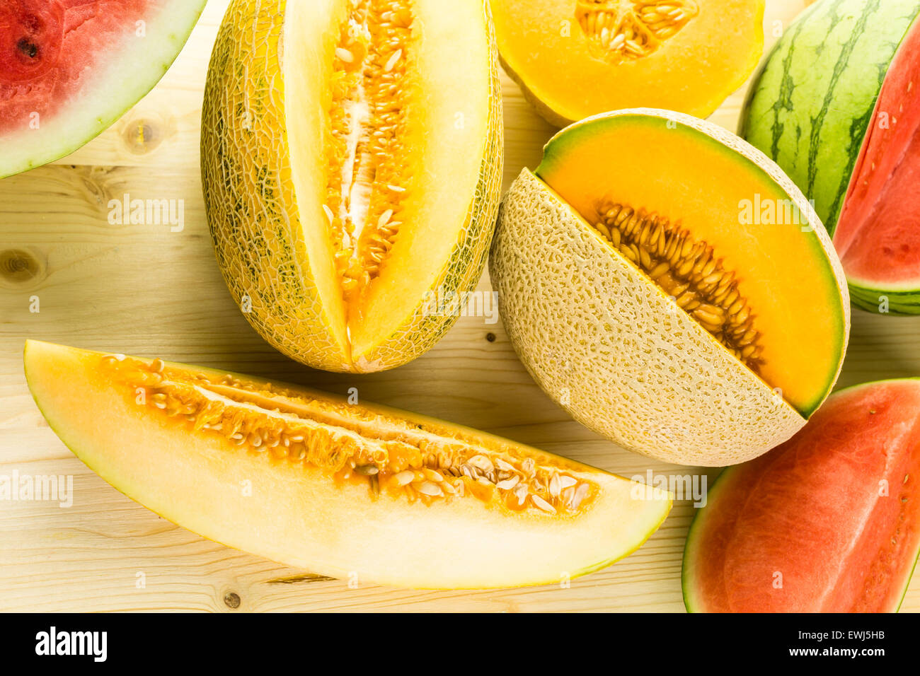 Variety of organic melons sliced on wood table Stock Photo - Alamy