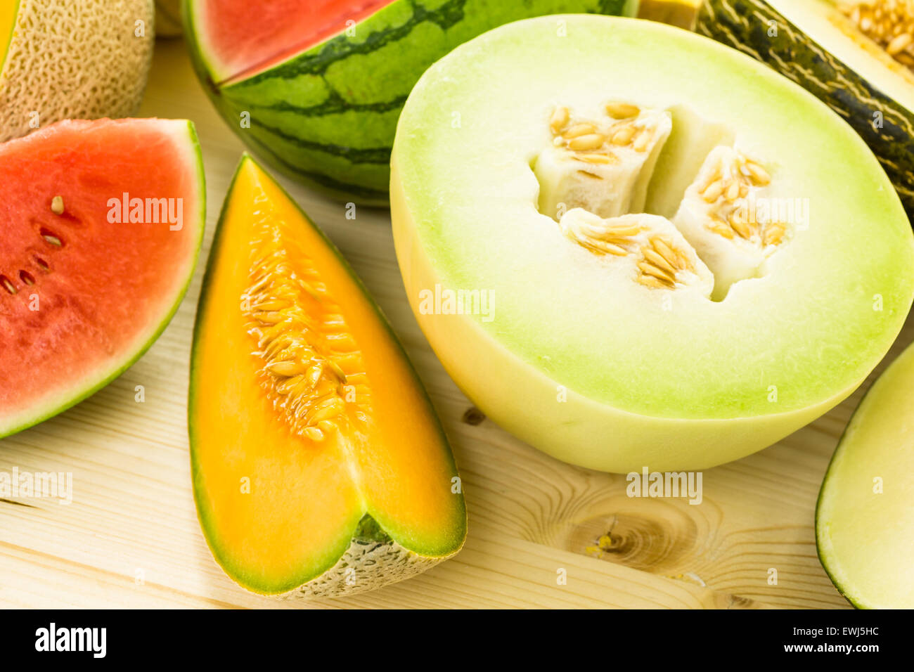 Variety of organic melons sliced on wood table Stock Photo - Alamy