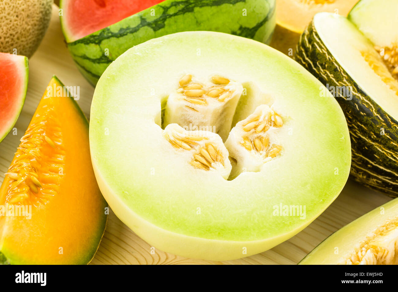 Variety of organic melons sliced on wood table Stock Photo - Alamy